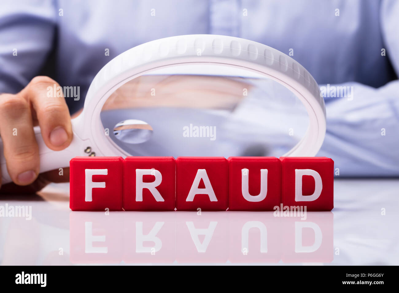 Human Hand Holding Magnifying Glass Over The Fraud Word Block Stock ...