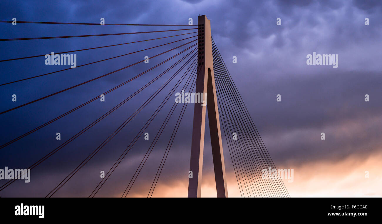 High suspended road bridge in Germany against a dark stormy sky at ...