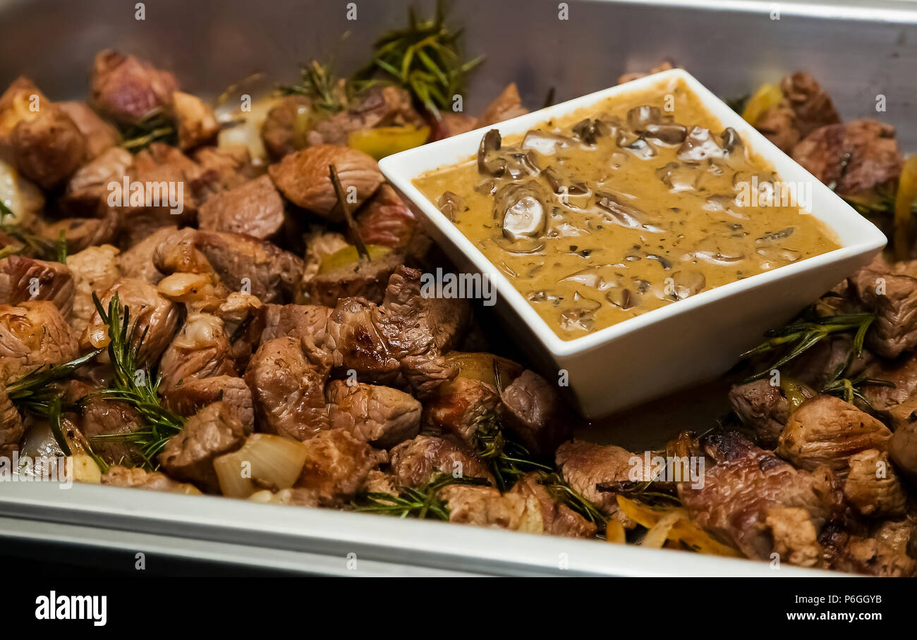 Large bowl of freshly roasted slices or prime beef for catering at a ...
