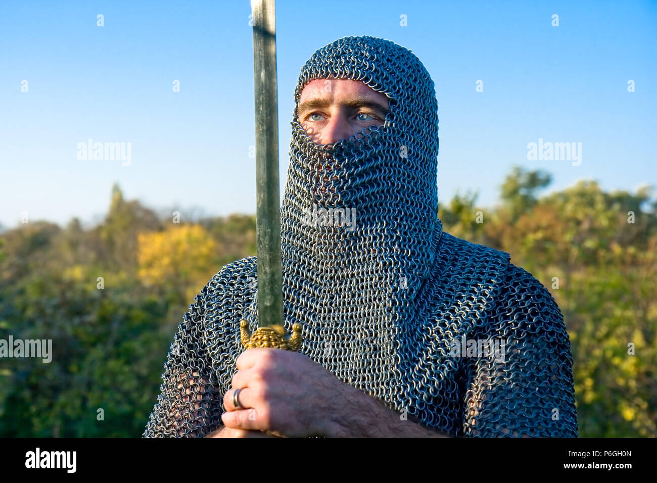 Knight warrior wearing armour and hold on a sword Stock Photo - Alamy