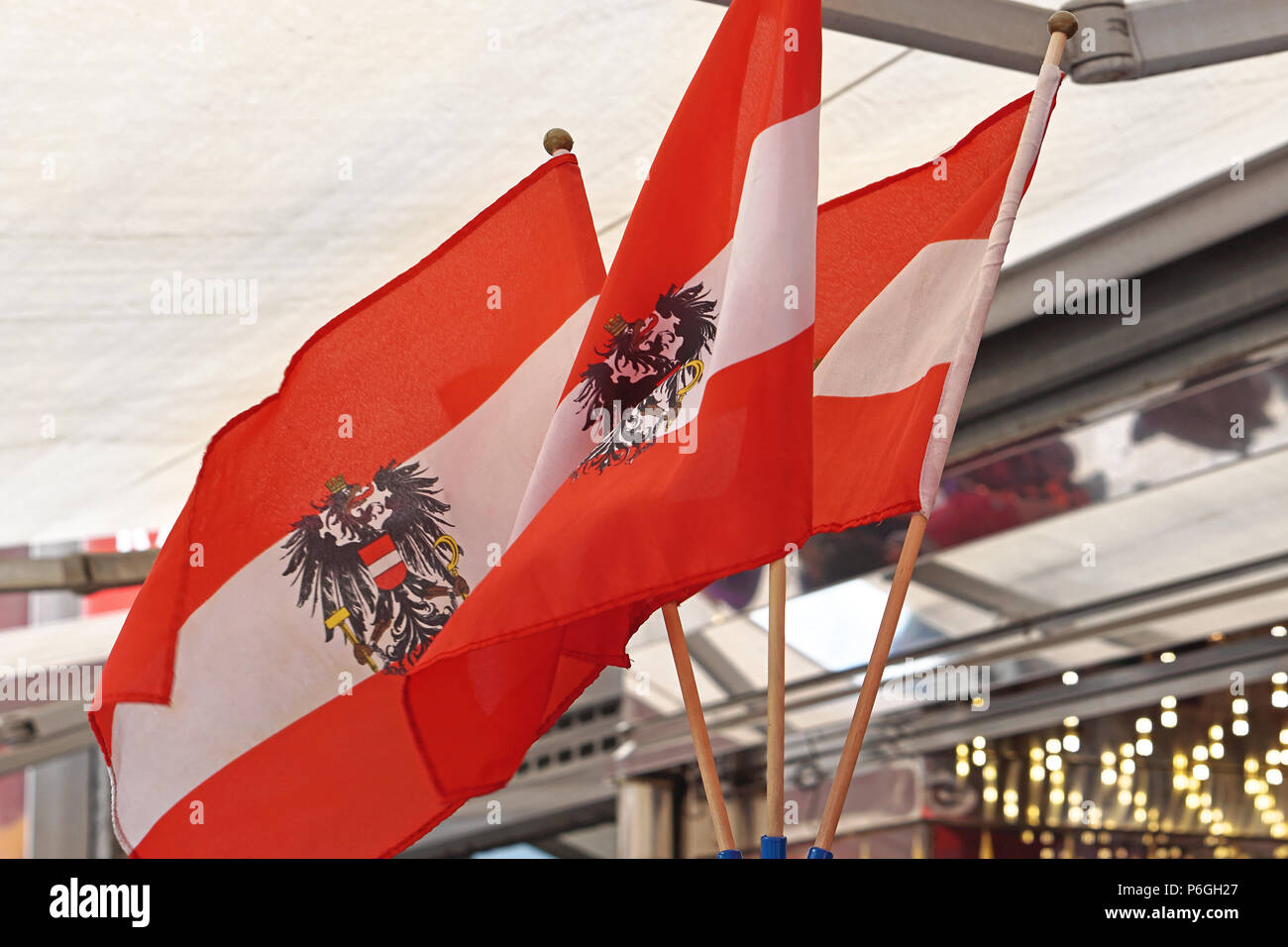 Three Austrian flags with eagles Stock Photo - Alamy