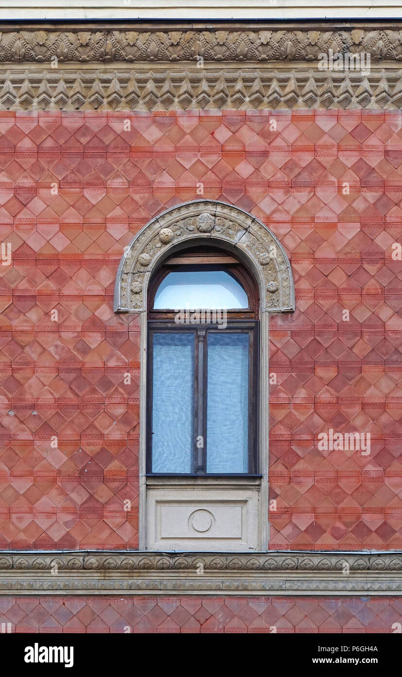 Arch window at classic style building with red facade Stock Photo - Alamy