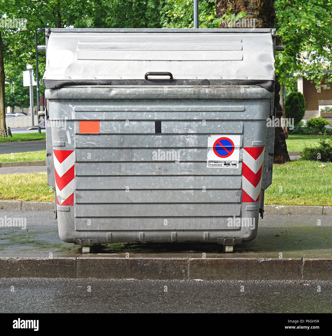 Big metal waste container for communal use Stock Photo - Alamy