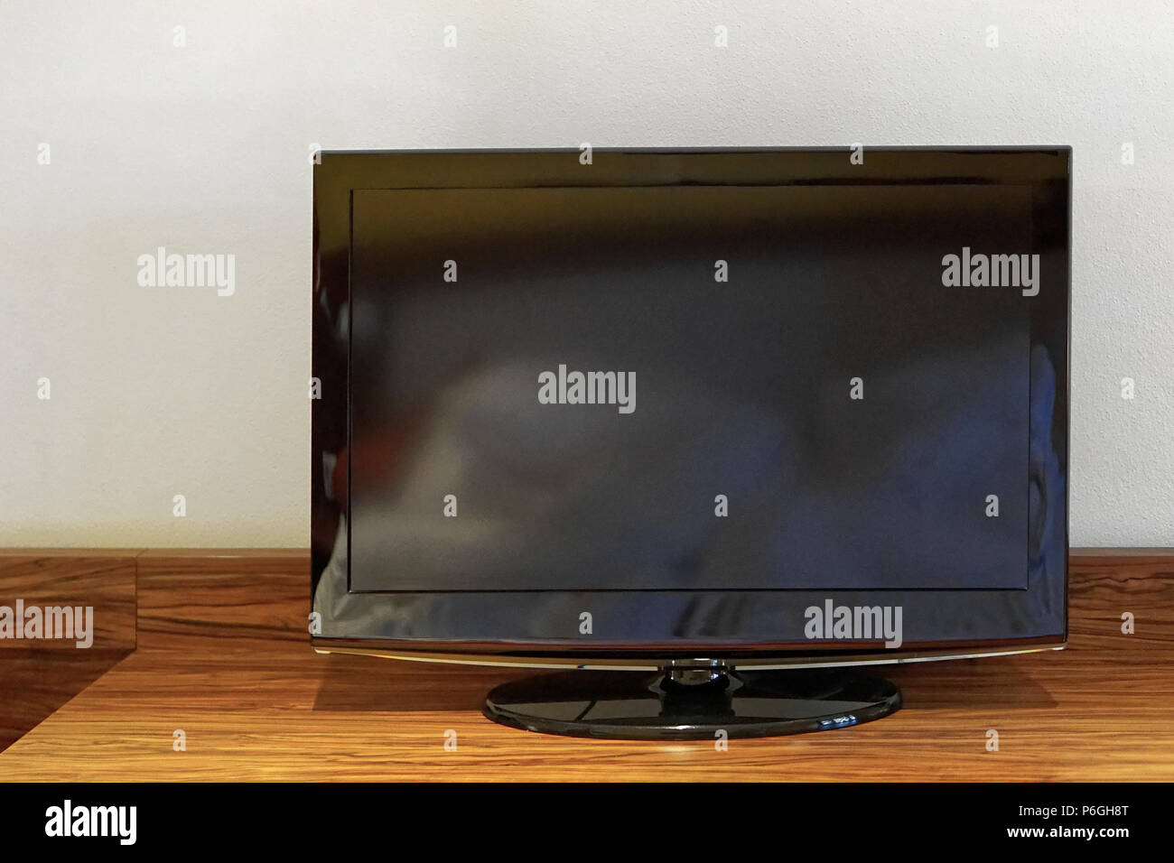 Black lcd TV set at wooden shelf Stock Photo - Alamy