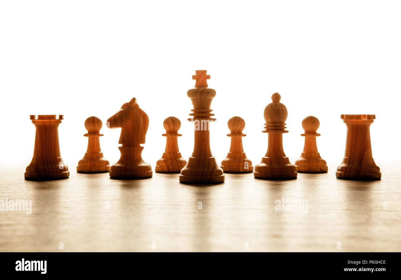 wooden white chess pieces lined up in a row on a white background Stock ...