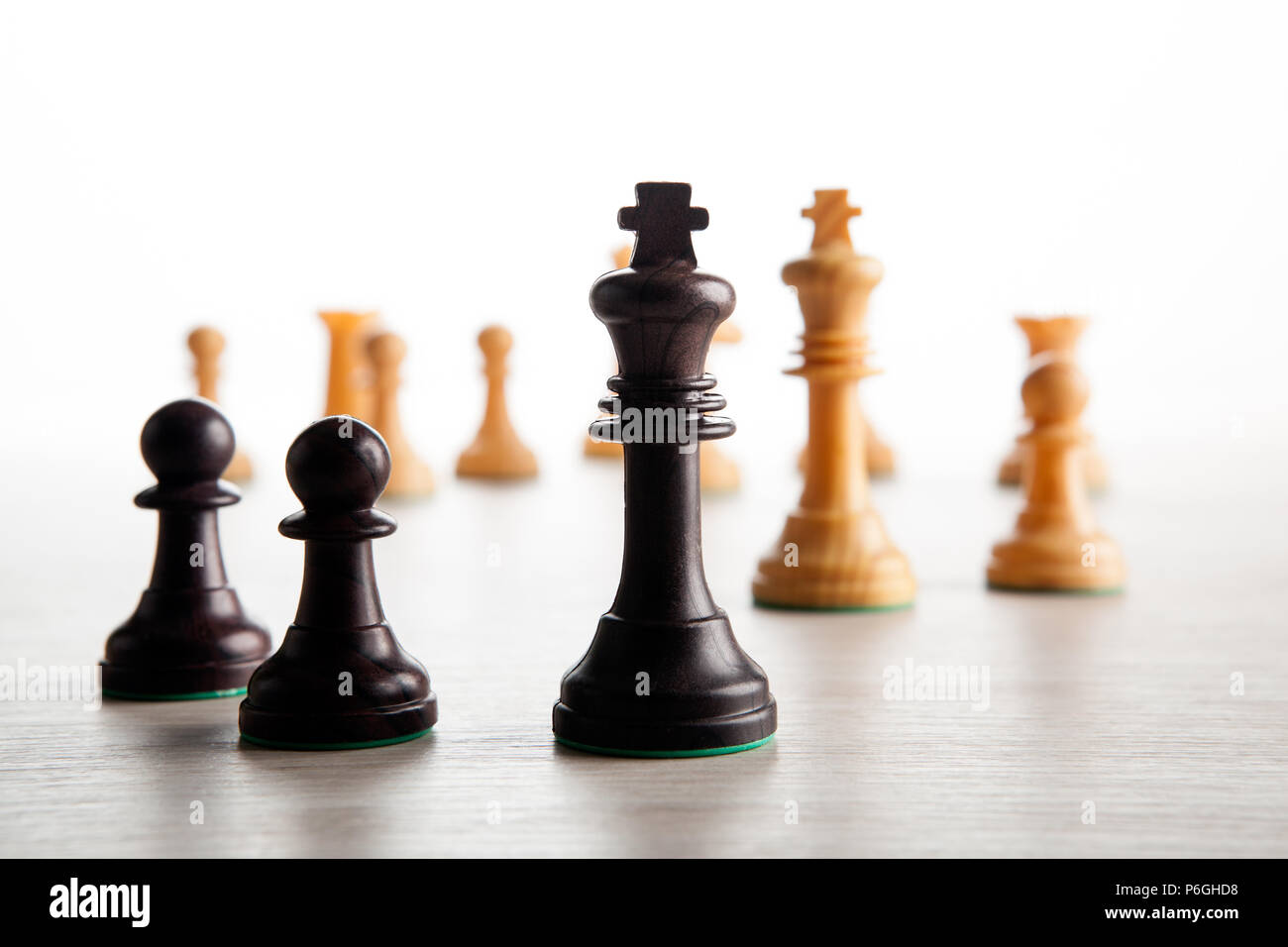 black chess pawns on a chessboard and a black chess king a white ...