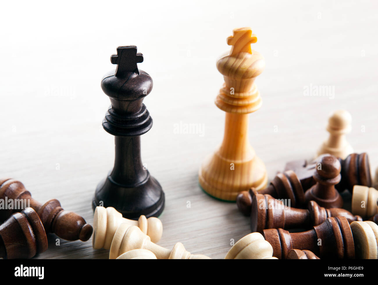 chess duel of two kings and other chess pieces on a grey background ...
