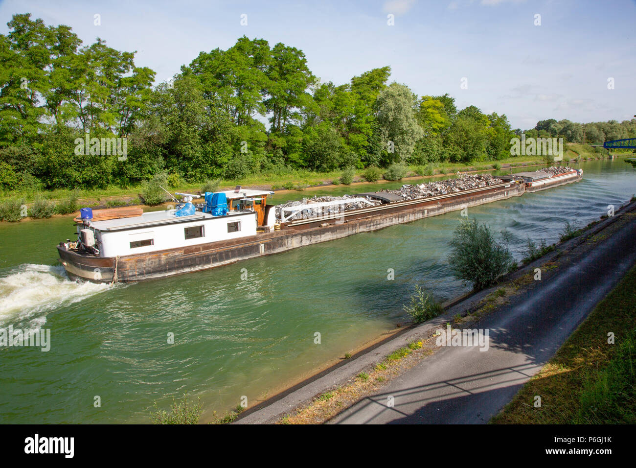 A barge of scrap metal passing along the Canal du Nord in France Stock ...