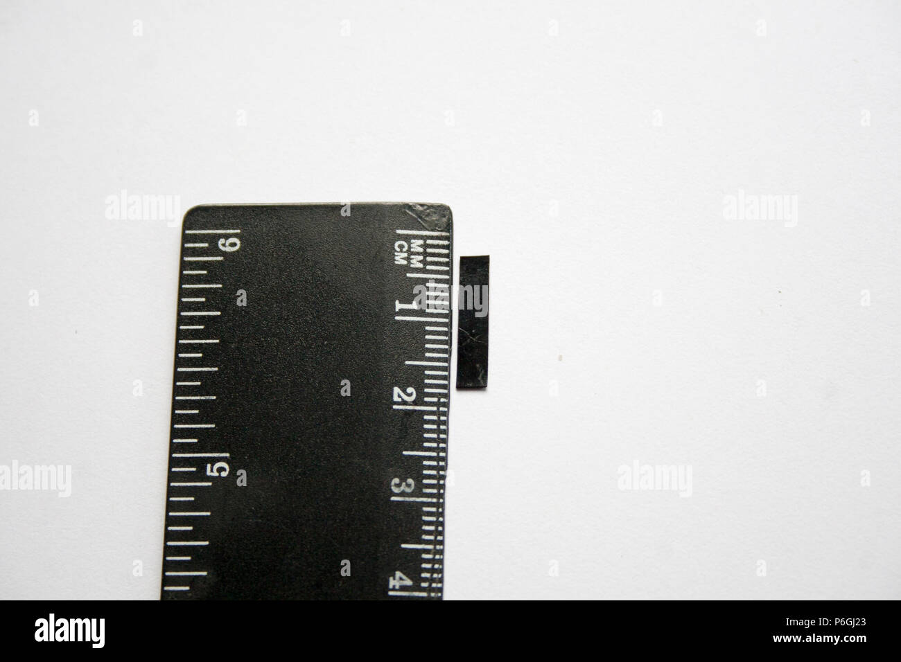 measuring a strip of black material Stock Photo - Alamy