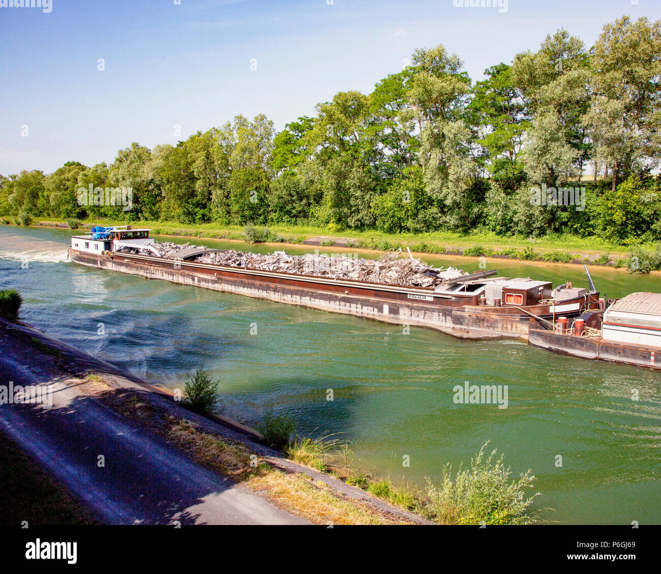 A barge of scrap metal passing along the Canal du Nord in France Stock ...