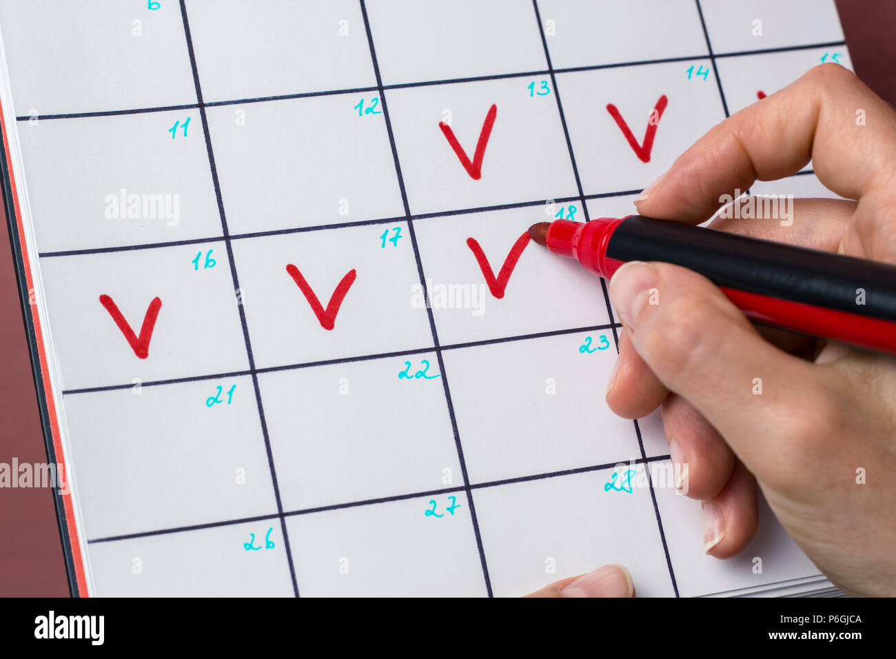 A woman marks the days of menstruation in the calendar period Stock ...