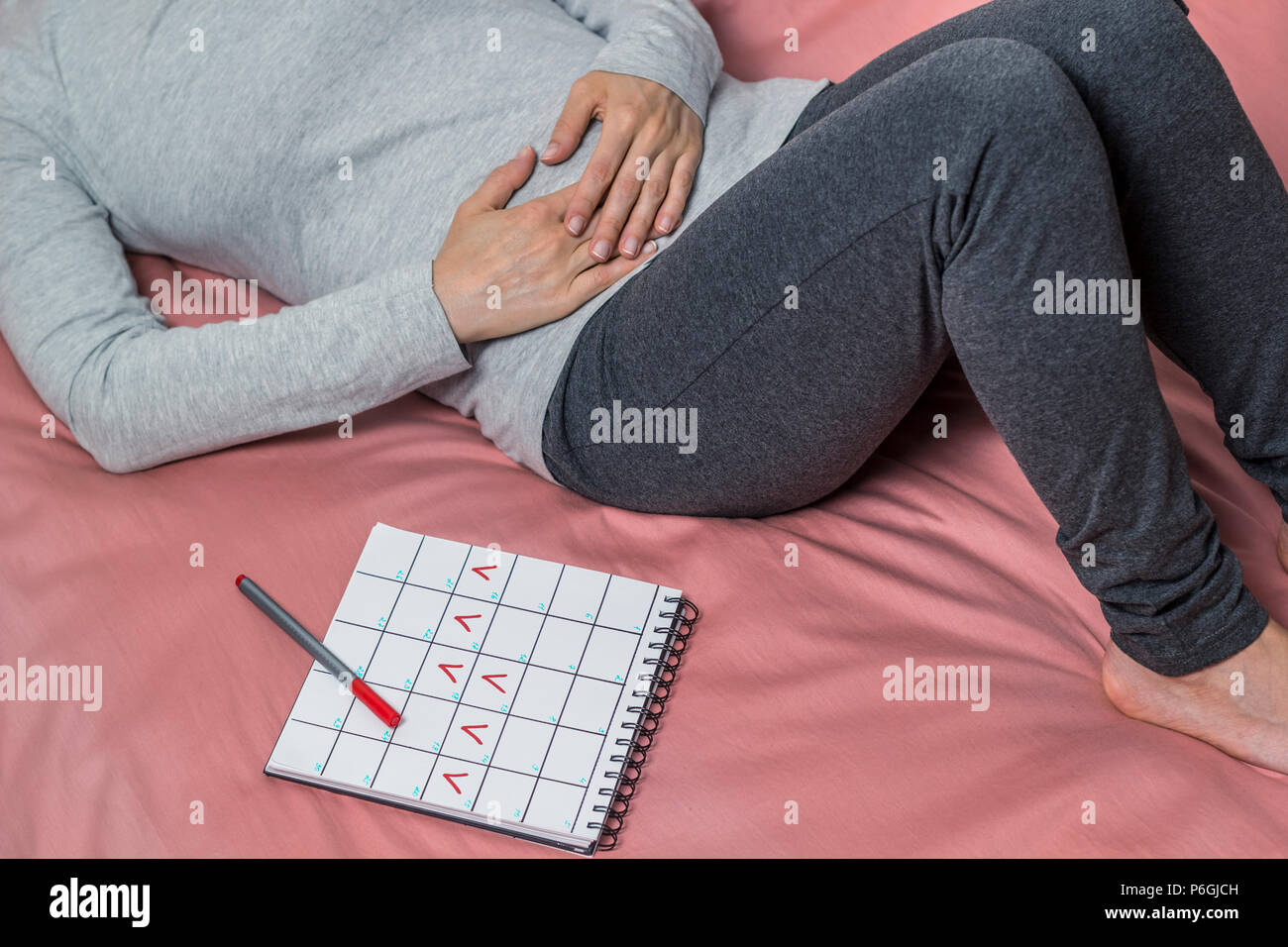 Pain in the abdomen during a woman's period. Distressed monthly ...