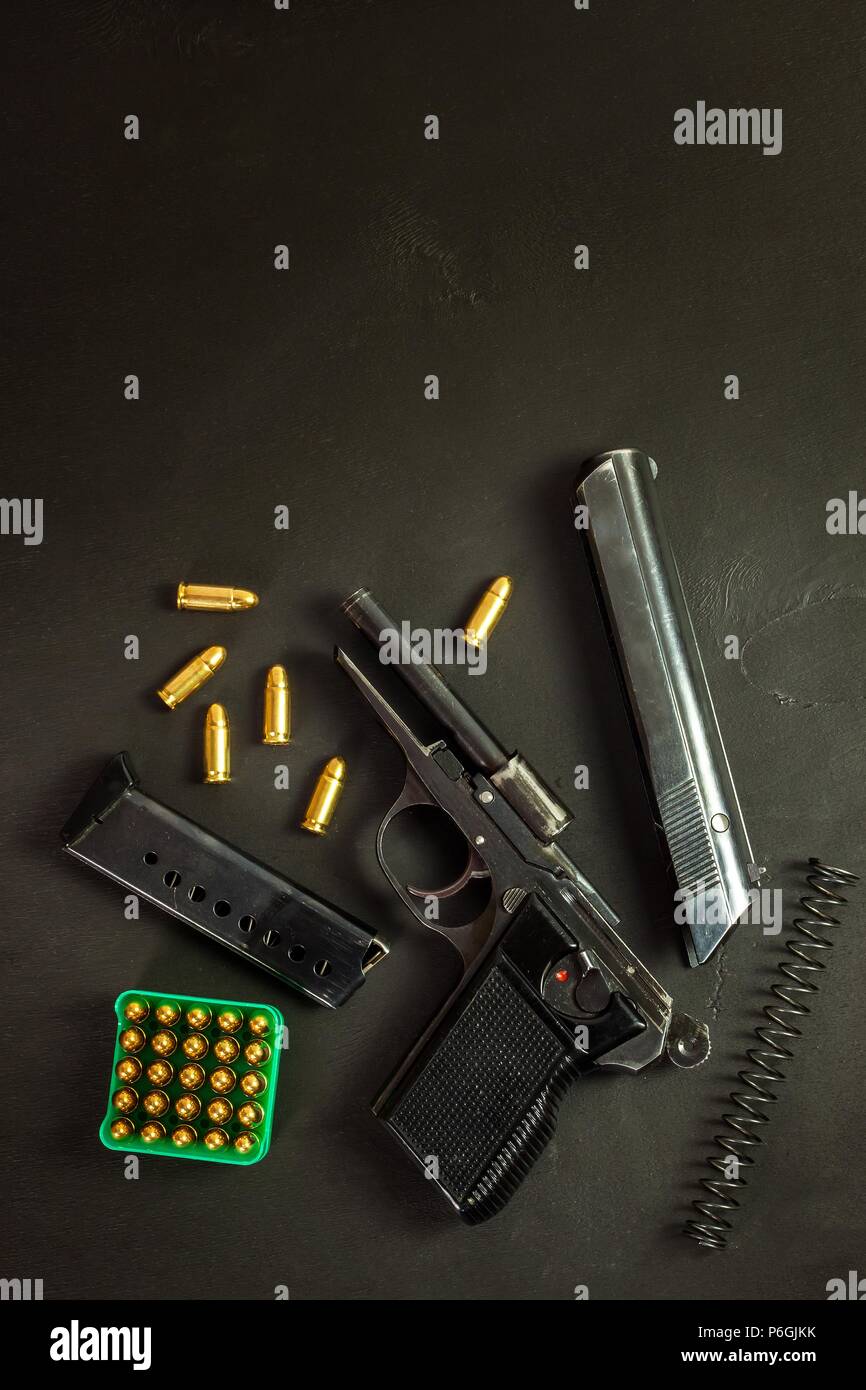 Disassembled pistol on black background. Separated pistol parts. Gun ...