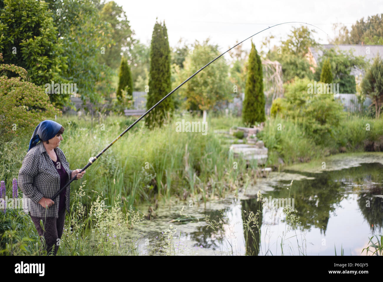 Older woman fishing hi-res stock photography and images - Alamy