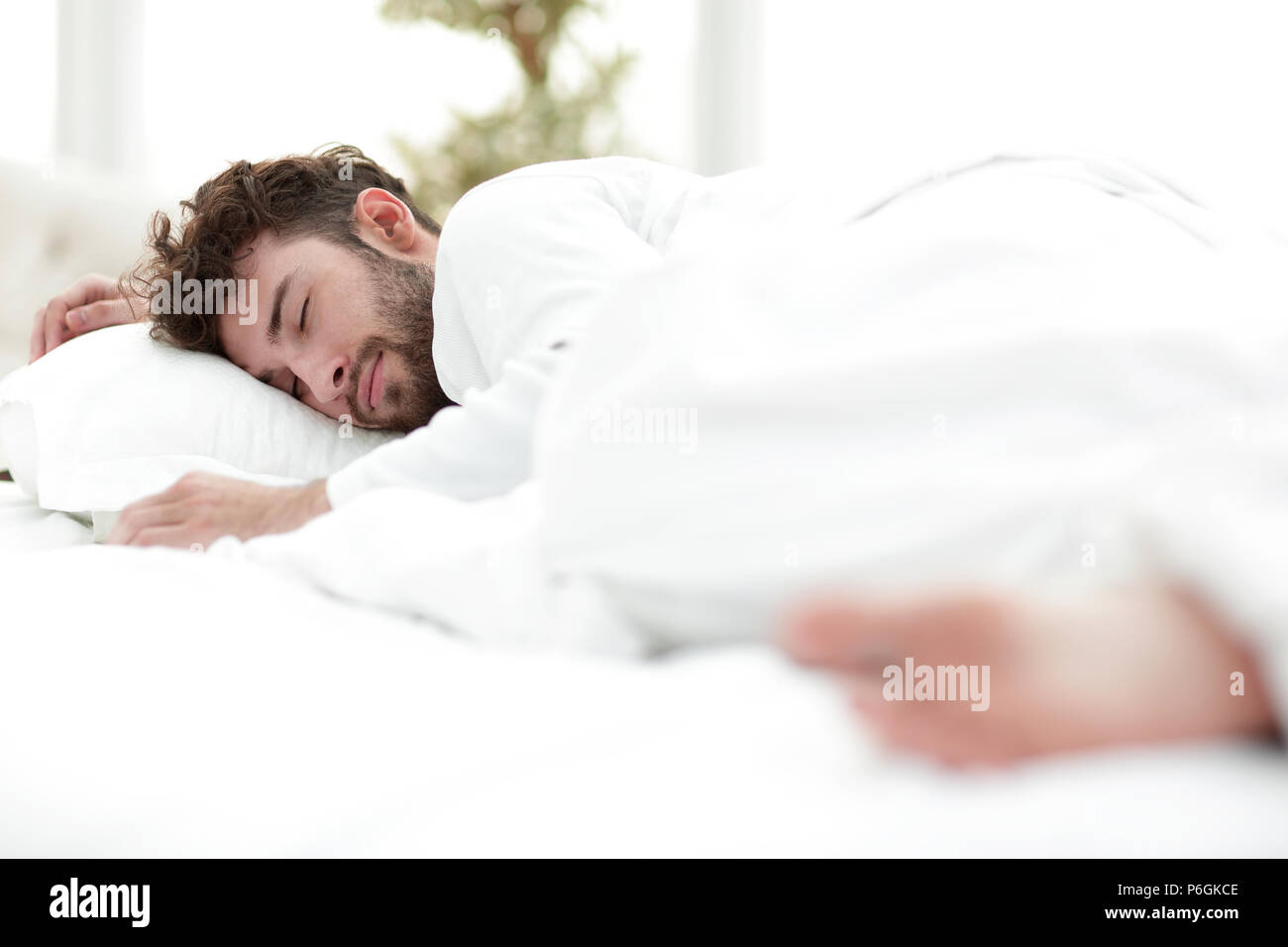 closeup.the tired men sleep soundly on the bed Stock Photo - Alamy