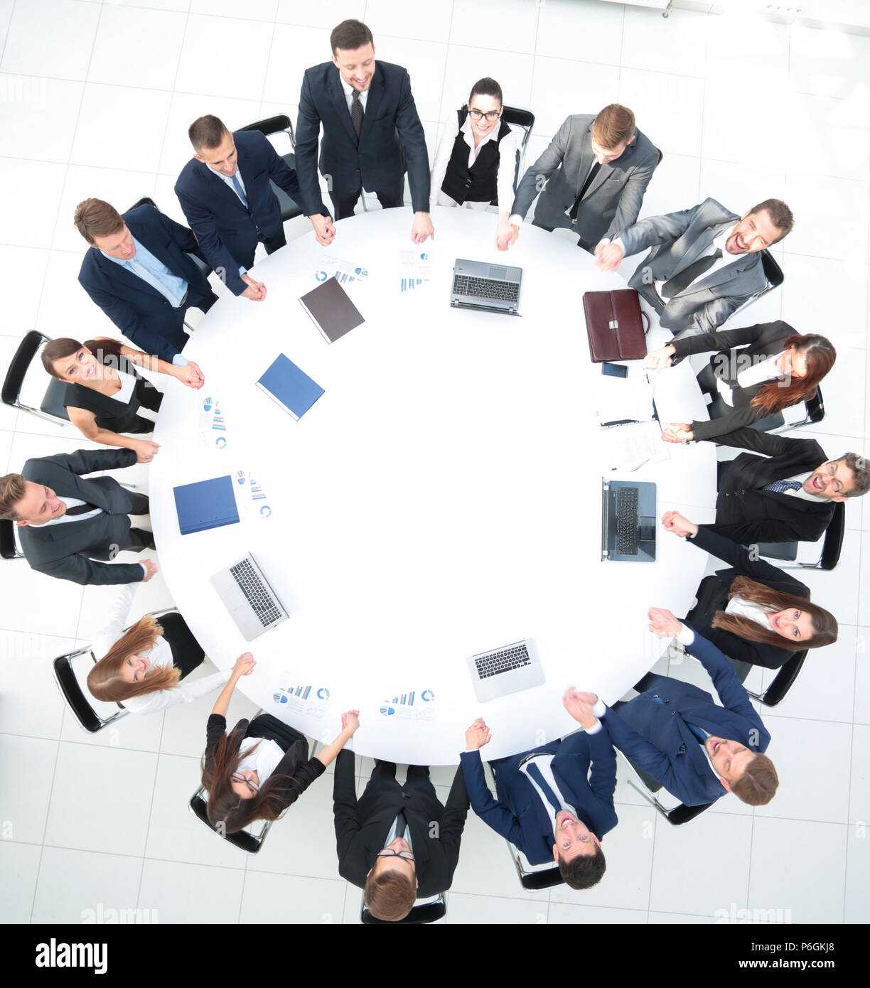 large business team sitting at the round table and raising his hands up ...