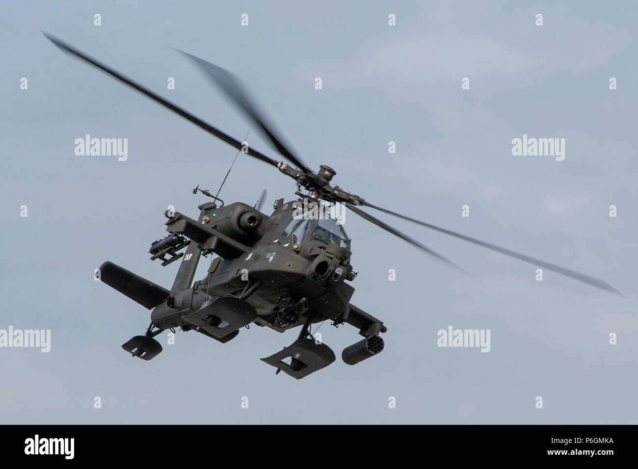 A U.S. Army AH-64 Apache attack helicopter makes a bank while providing ...