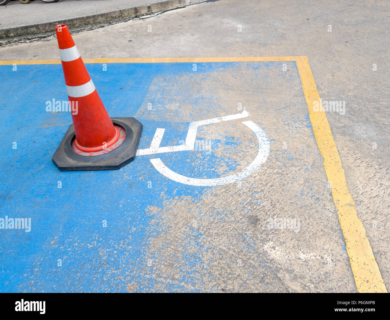traffic cone on Disabled parking. International Symbol of painted in ...