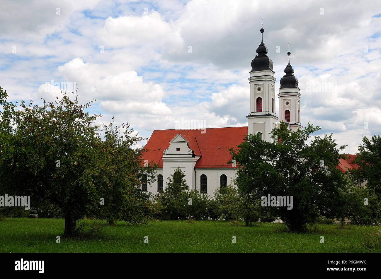 view over orchard to monastery church of Irsee, baroque landmark in the ...