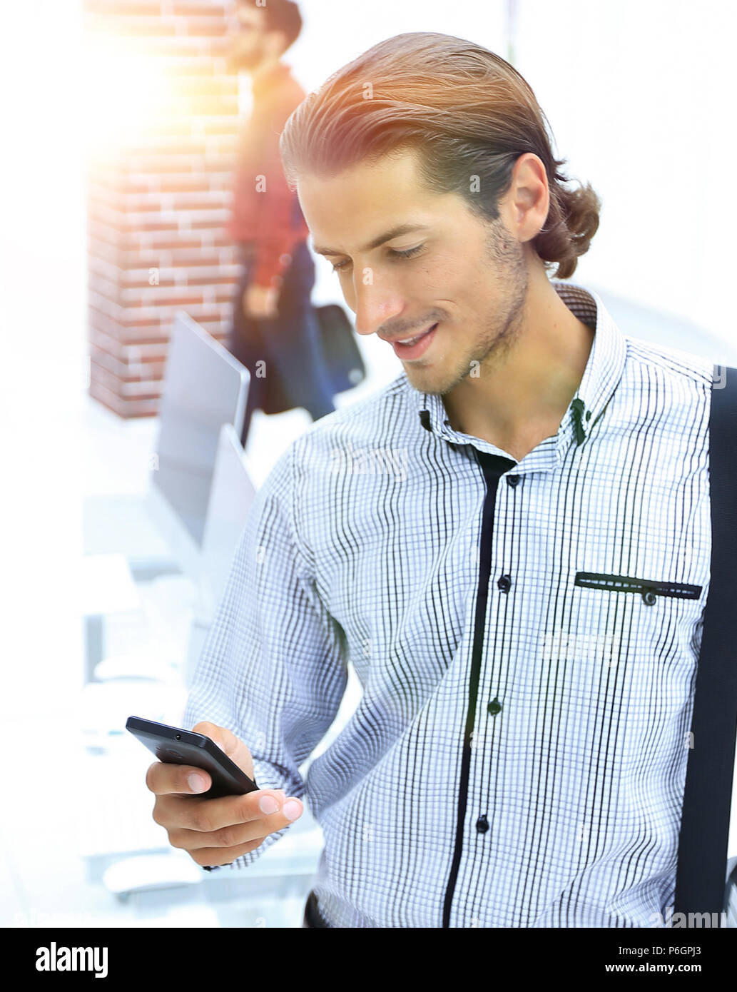 employee reads a text message on smartphone Stock Photo - Alamy