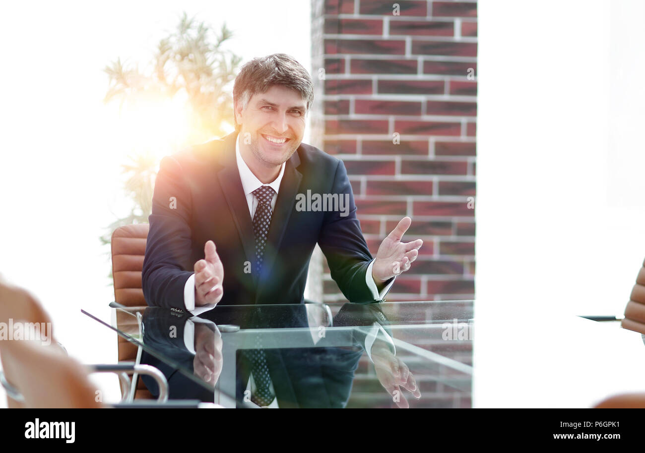 Successful businessman sitting in an empty desk Stock Photo - Alamy