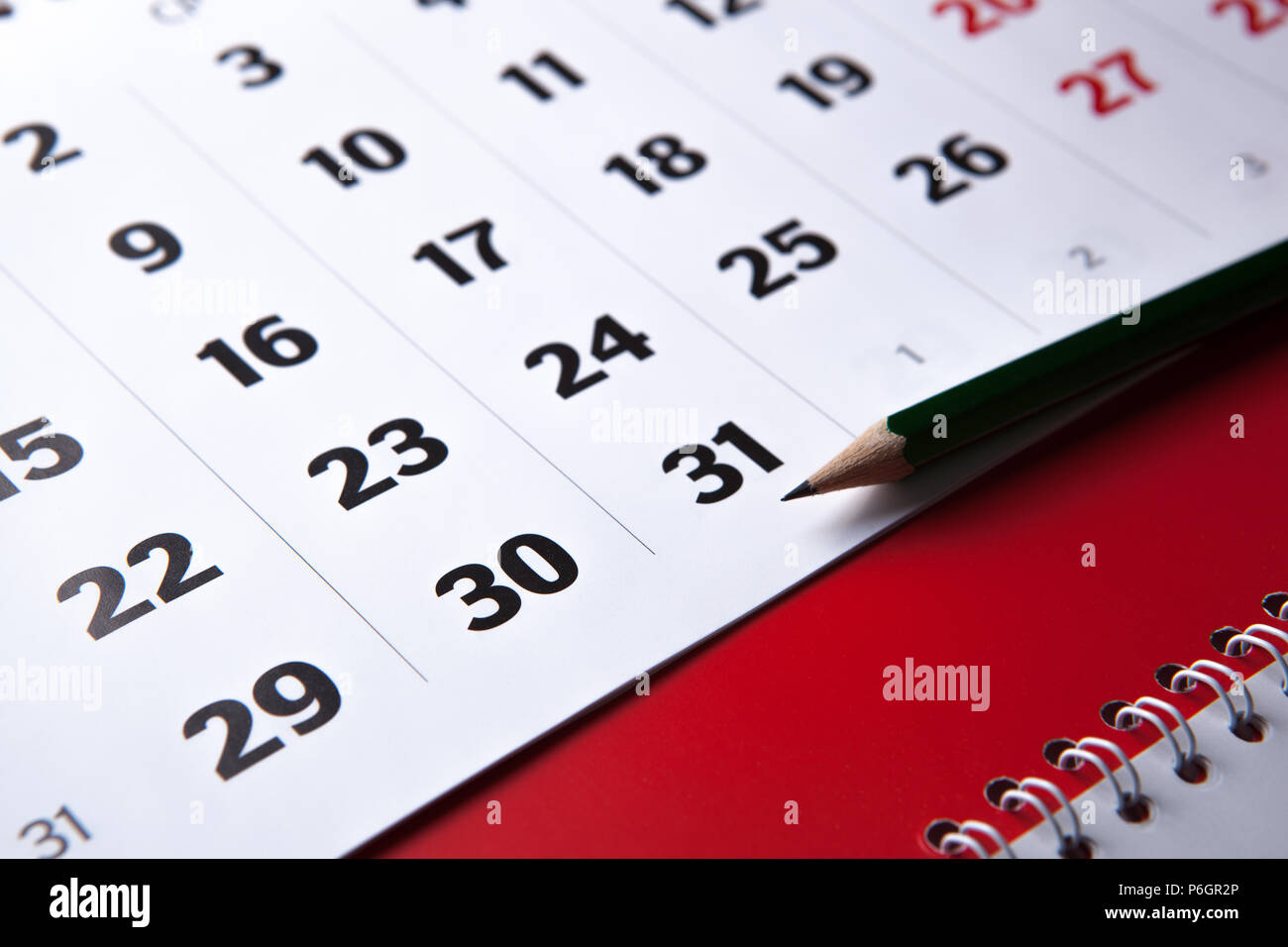 sheet of a calendar and a pencil close-up Stock Photo - Alamy