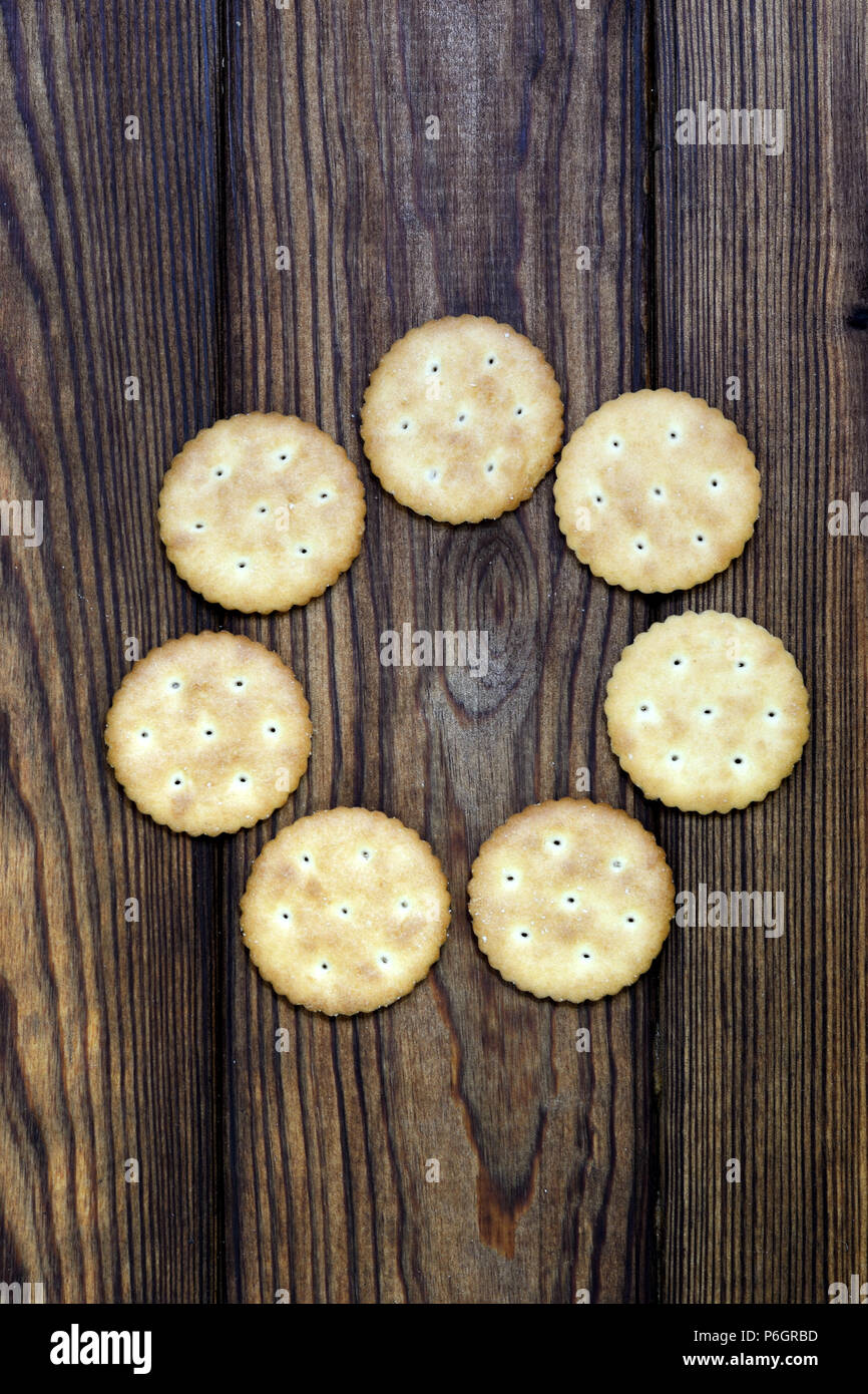 Cookies cracker laid in the form of a circle on a wooden background ...