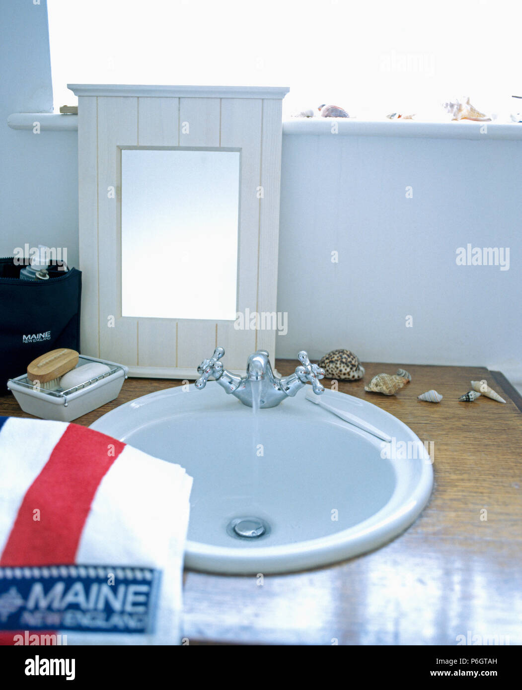 Close-up of white wooden mirror on vanity unit with small, circular ...