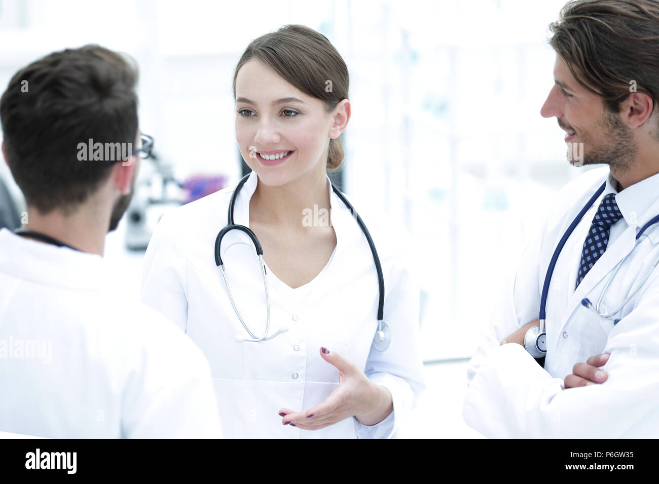 Team of different doctors having conversation Stock Photo - Alamy