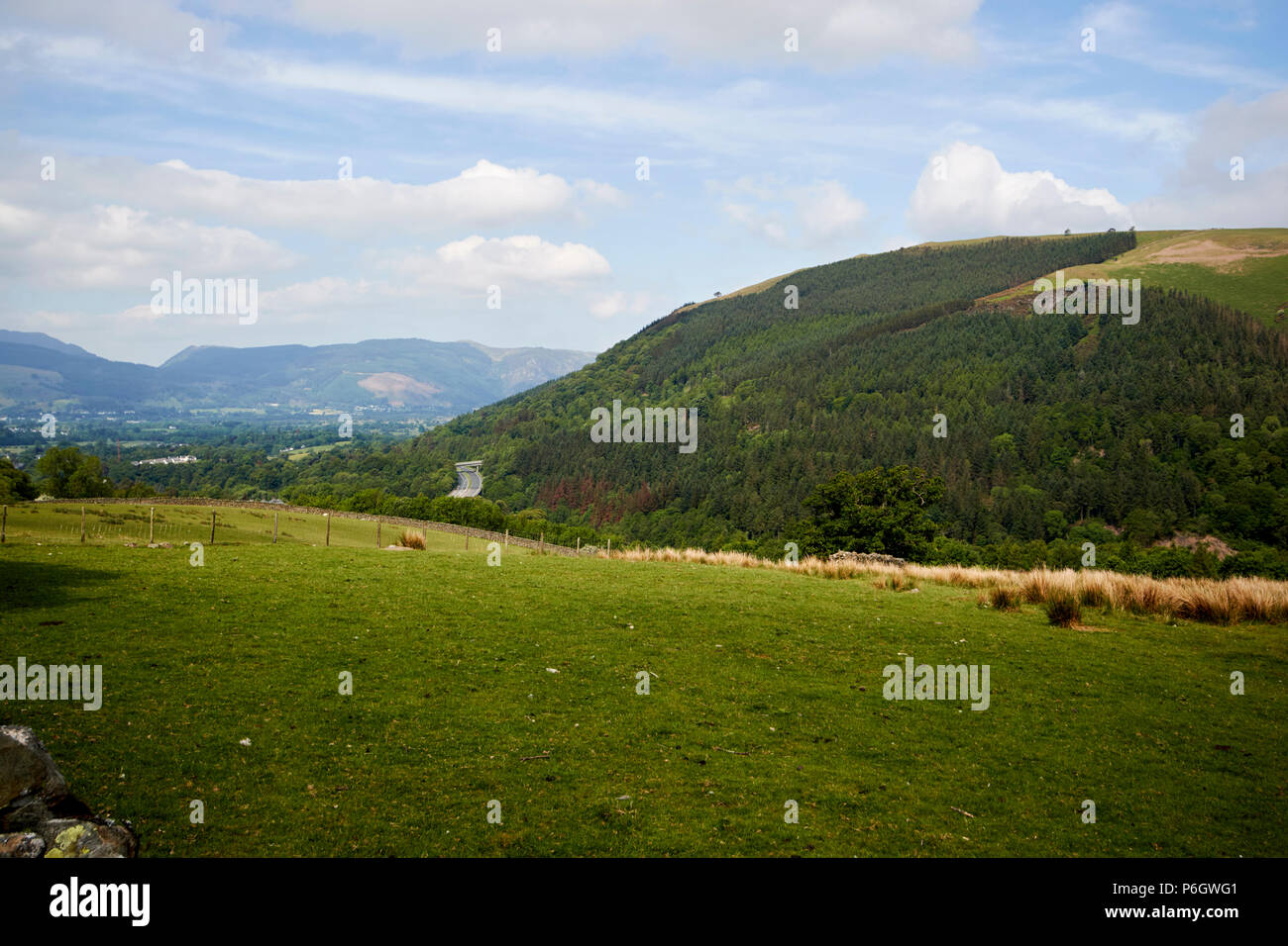 looking down over rural fields towards latrigg on the right and the a66 ...