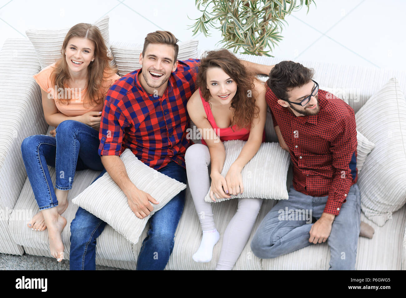 cheerful group of friends laugh ,sitting on the couch Stock Photo - Alamy