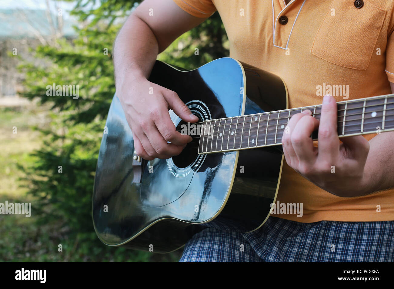 guitar acoustic black glossy six-string playing in nature Stock Photo ...