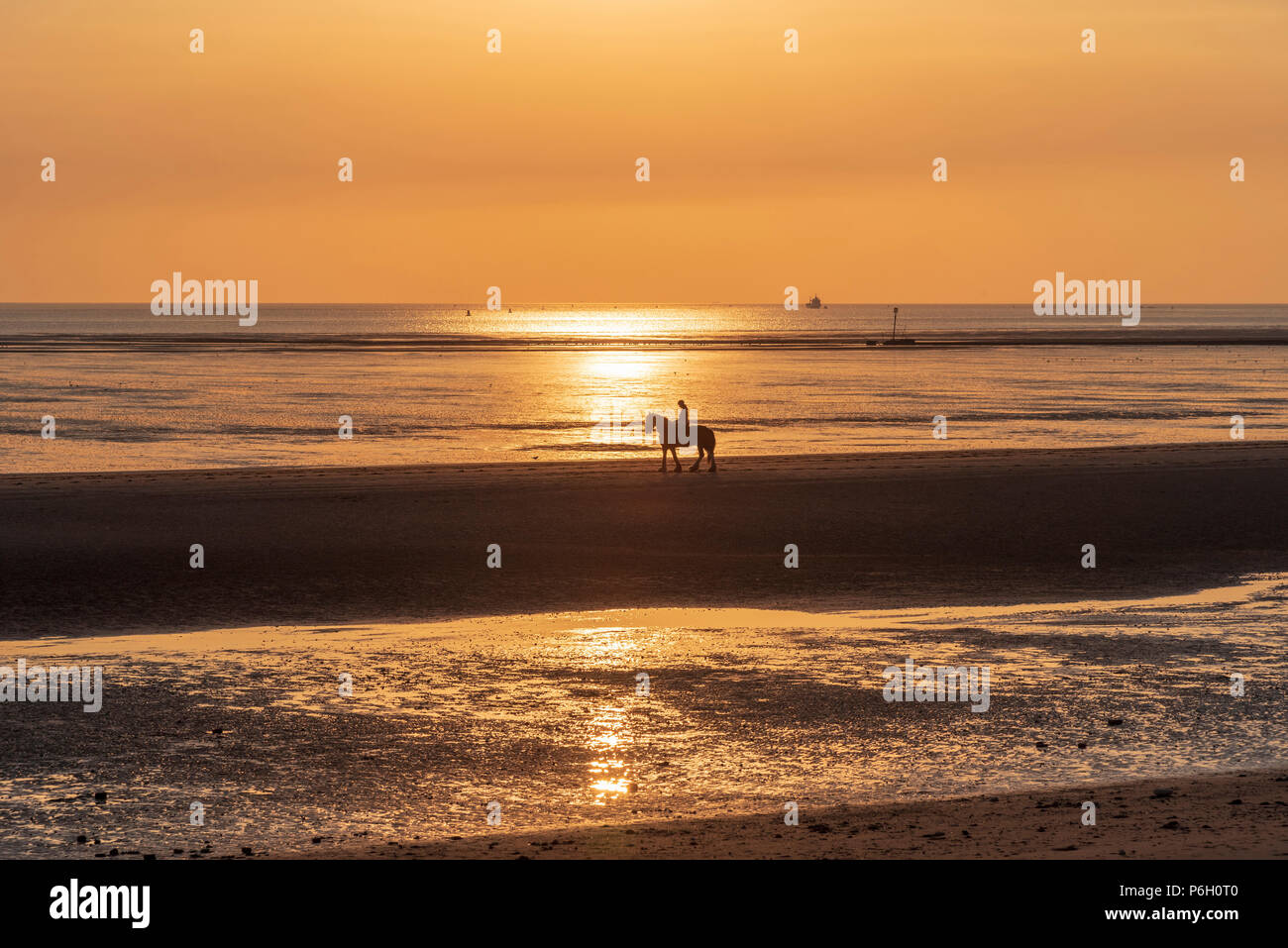 Sunset. Crosby beach. Liverpool North West England. Lone horse rider ...