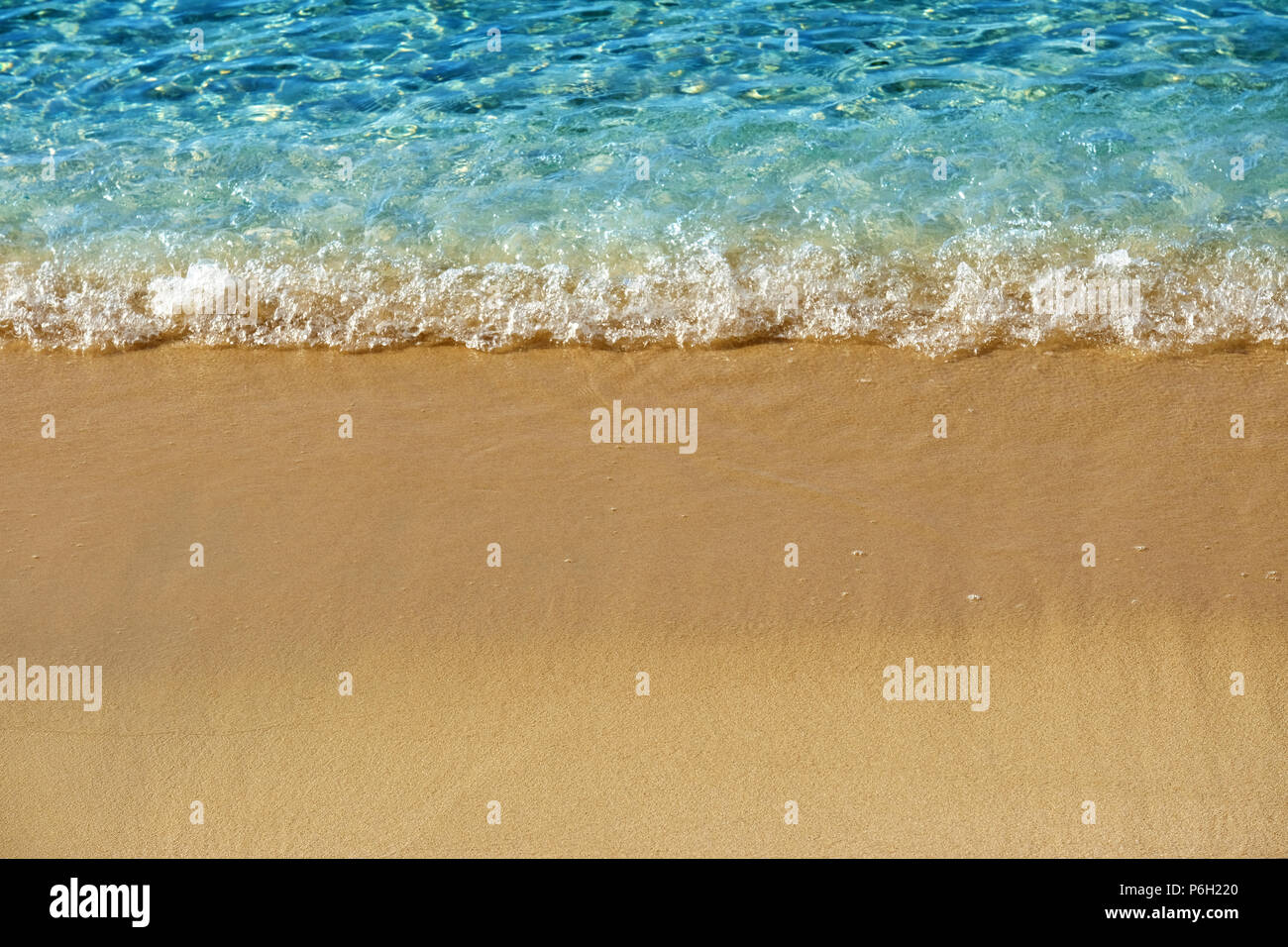 Ocean wave breaking on beach Stock Photo - Alamy