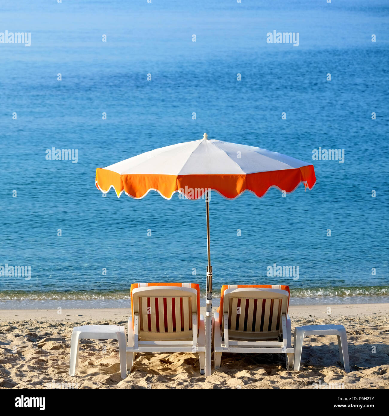 Mediterranean beach chairs and sun umbrella Stock Photo - Alamy