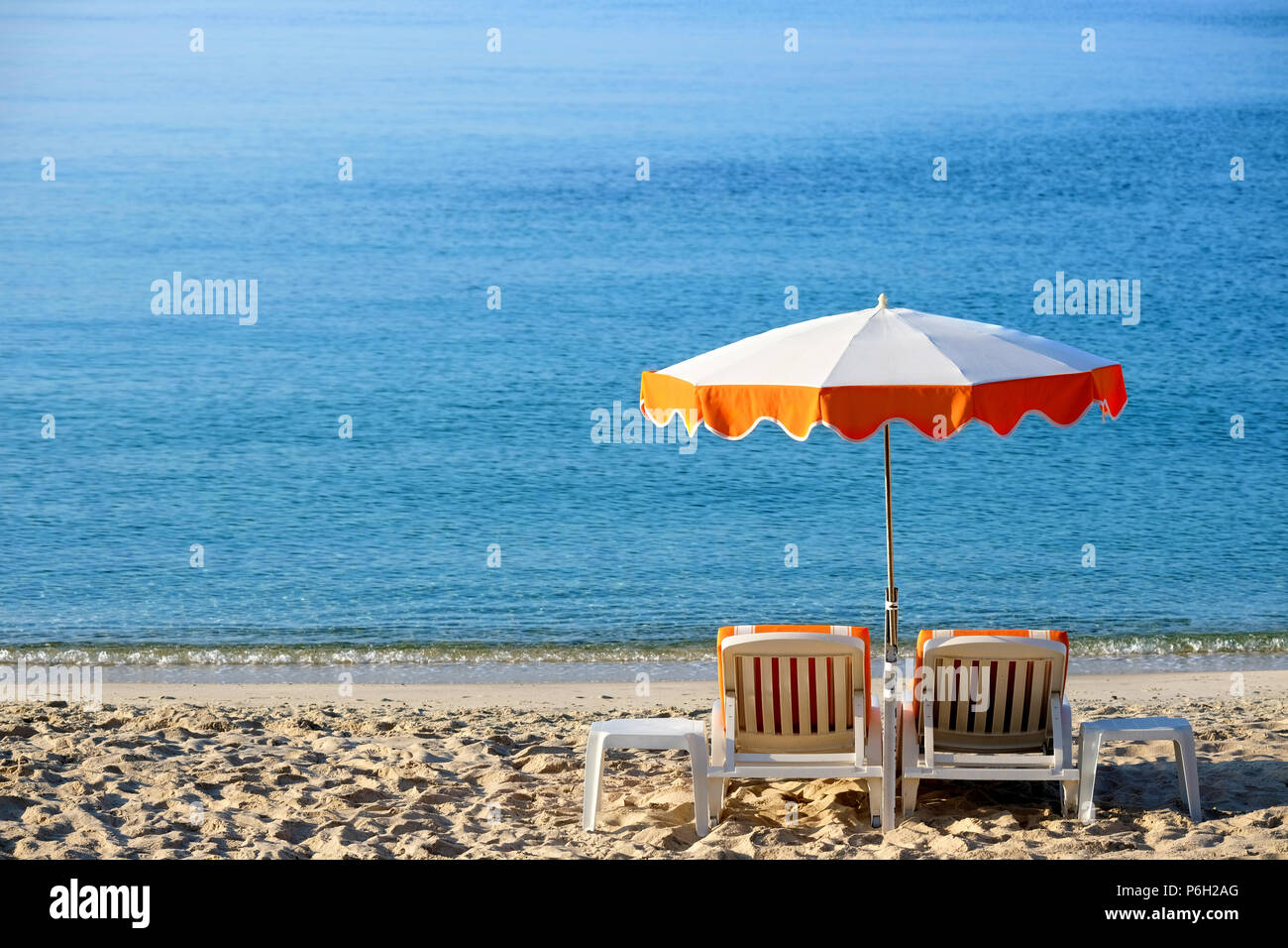 Mediterranean beach chairs and sun umbrella Stock Photo - Alamy