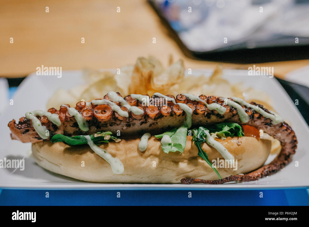 Sandwich with an octopus tentacle. Sea food Stock Photo - Alamy