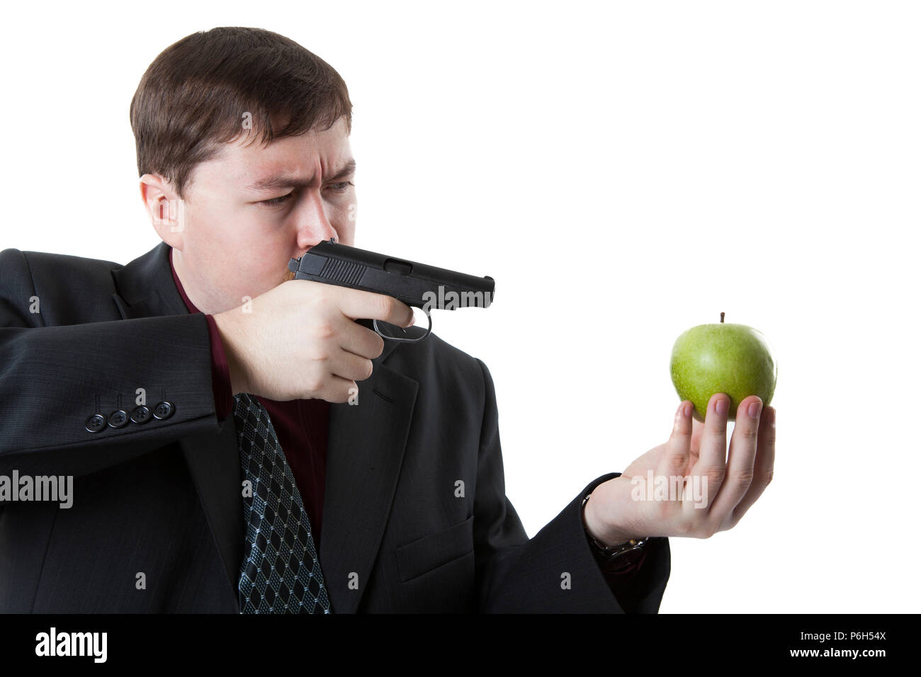 man aims at the apple on his hand on a white background Stock Photo - Alamy