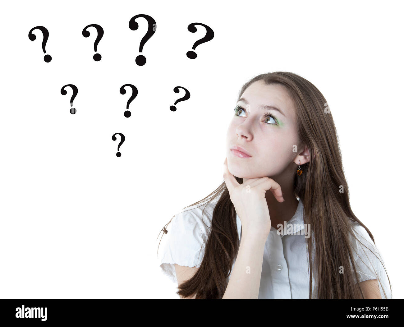 portrait of a girl thinking over the question on a white background ...