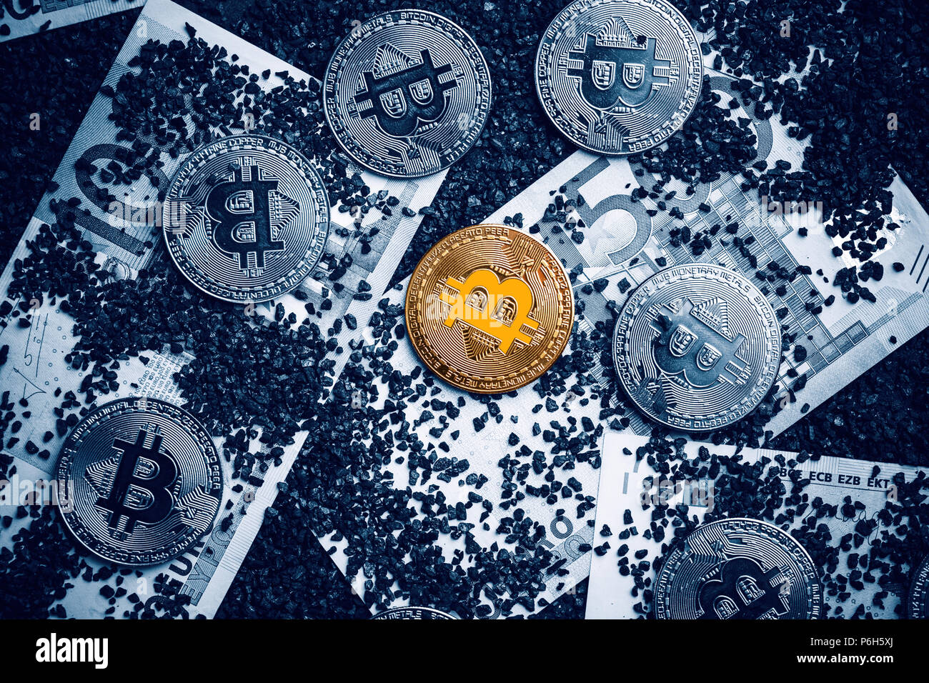 Gold Bitcoin BTC coins on bills of euro banknotes and on small black ...