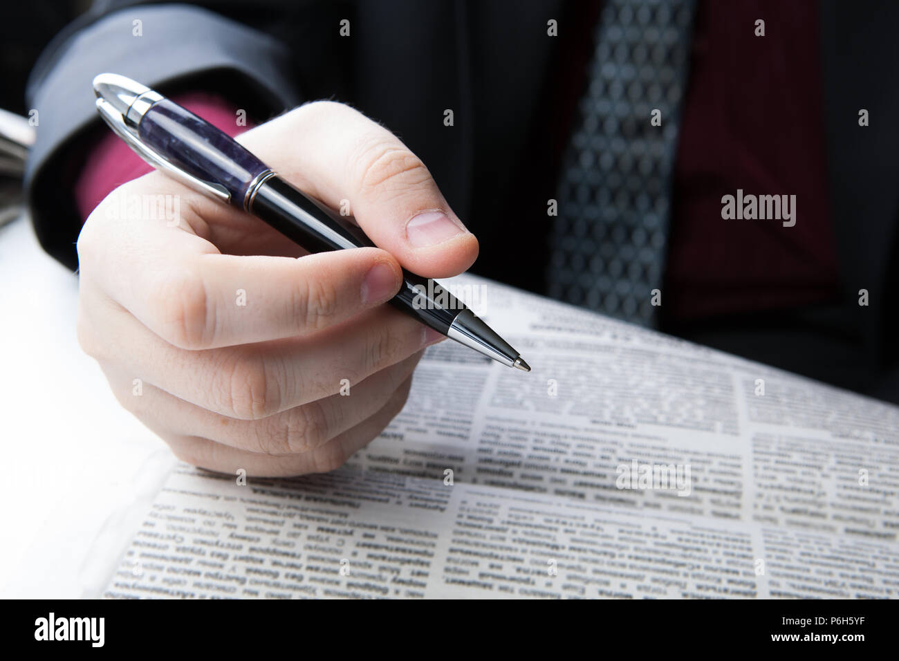 man is looking for information in the newspaper close-up Stock Photo ...