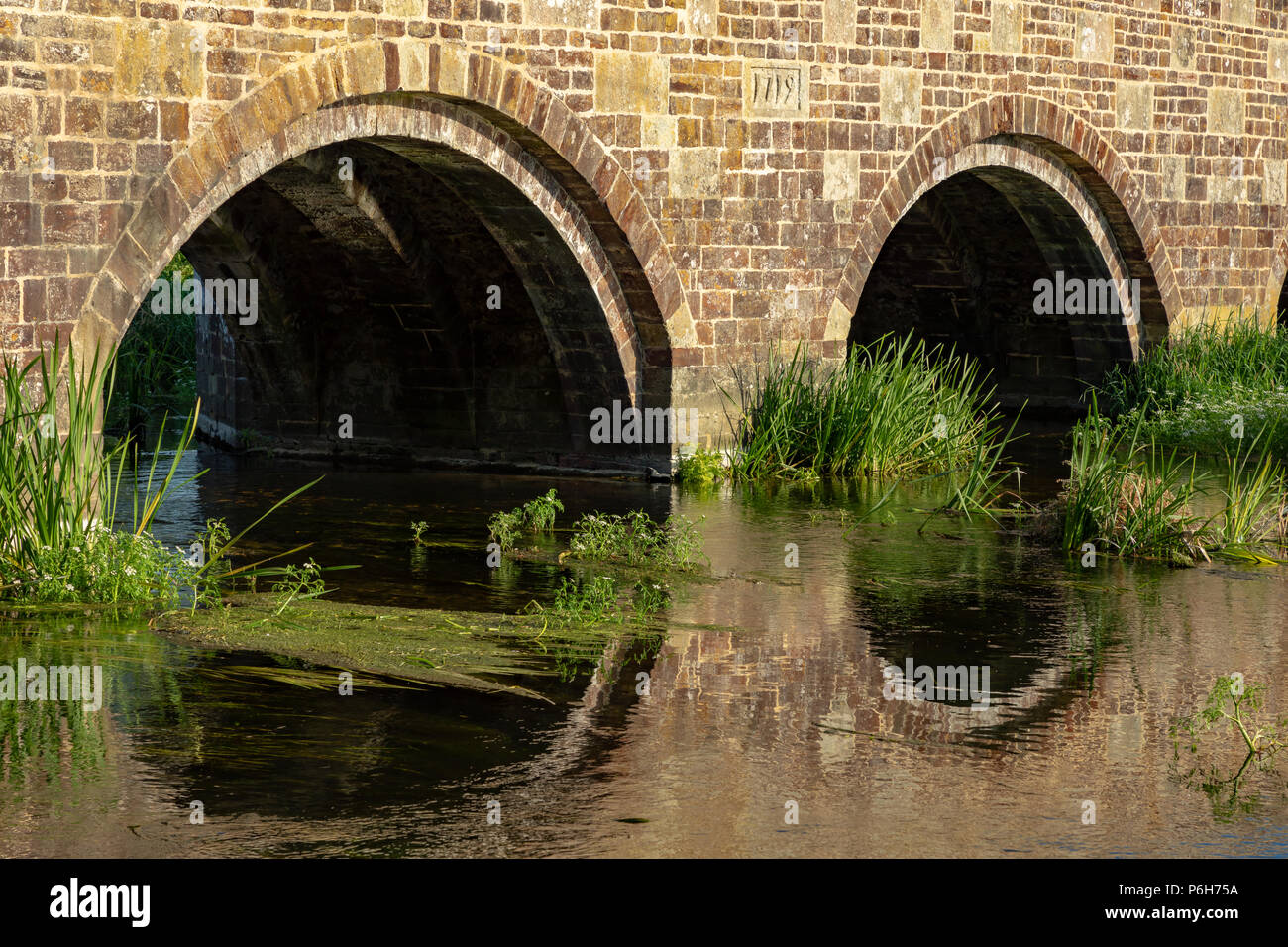 Spetisbury Dorset England June 30, 2018 Old stone bridge across the ...