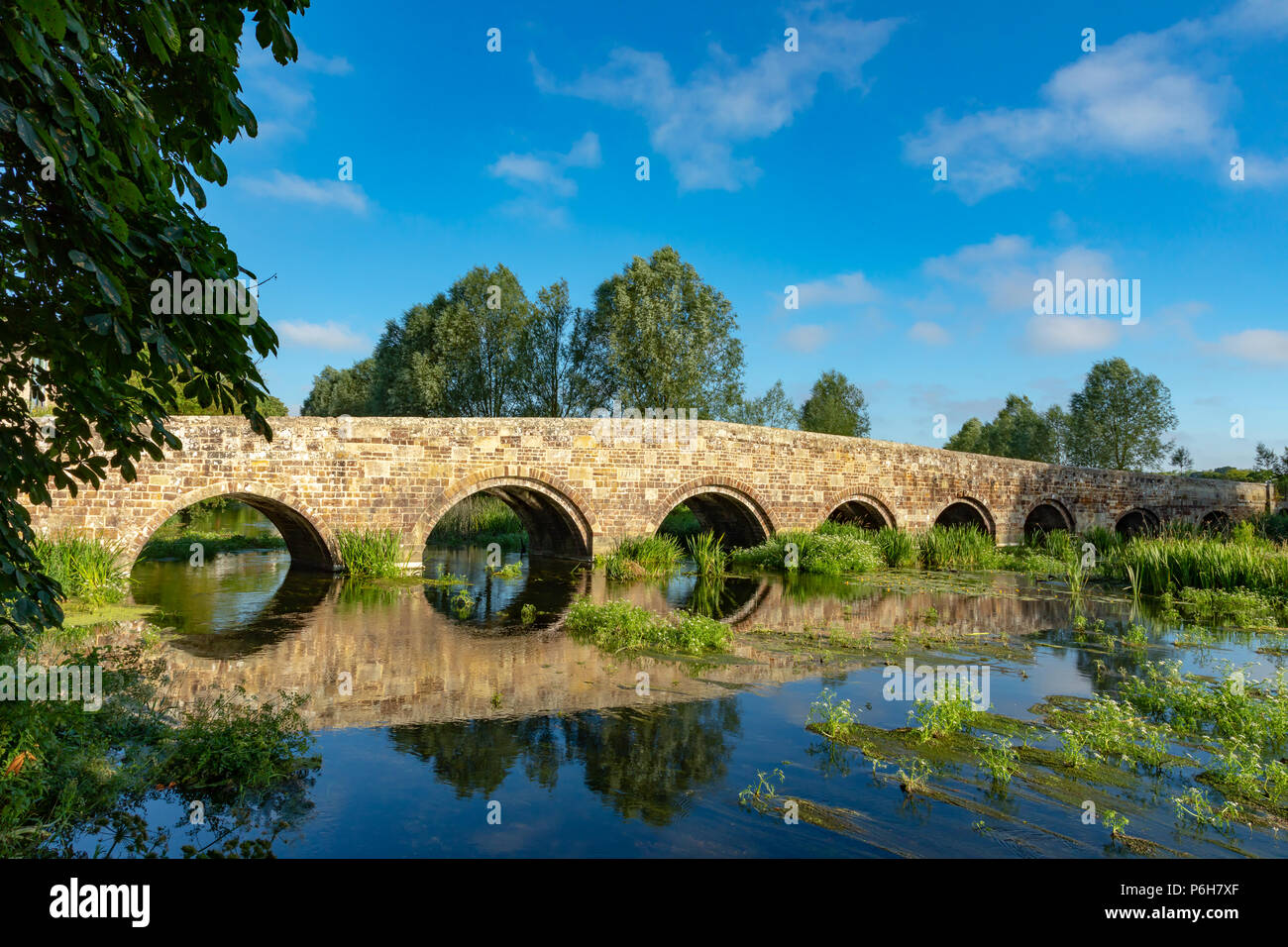 Spetisbury Dorset England June 30, 2018 Old stone bridge across the ...