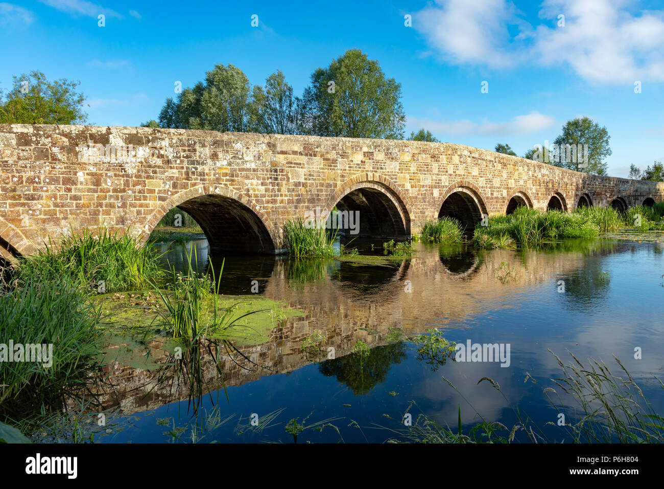 Spetisbury Dorset England June 30, 2018 Old stone bridge across the ...