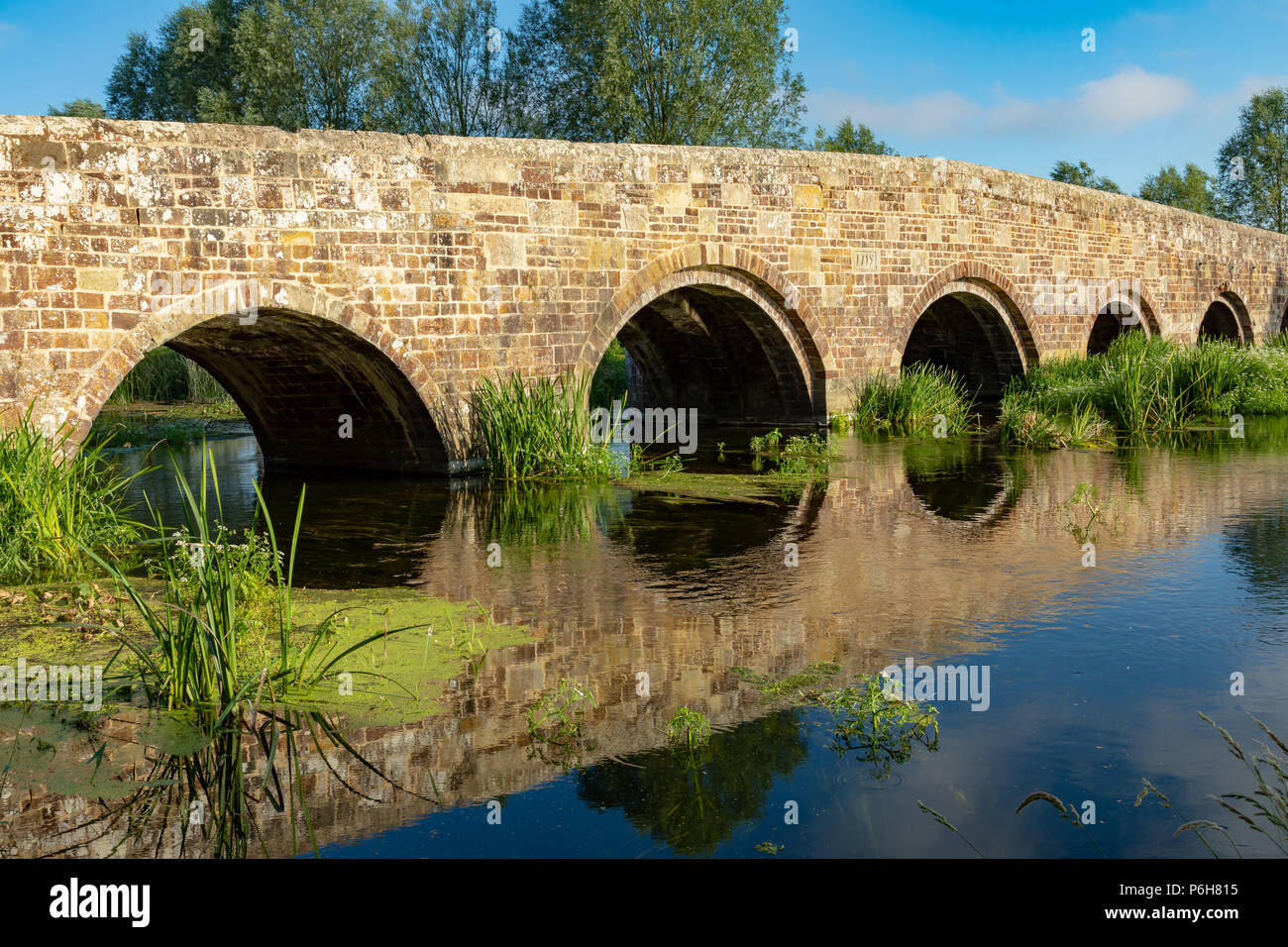 Spetisbury Dorset England June 30, 2018 Old stone bridge across the ...
