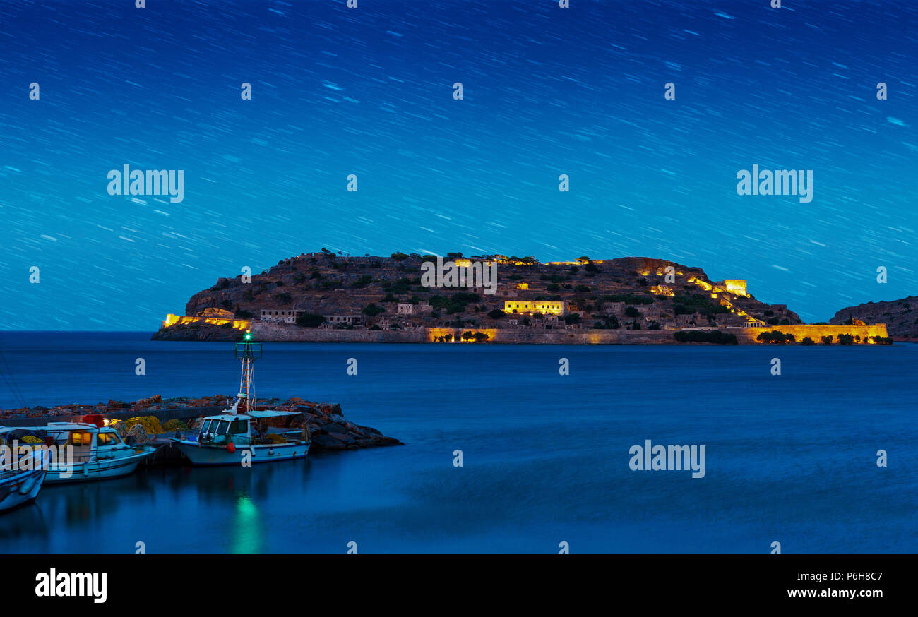 View of Spinalonga Island at night, view from the pier of the village ...