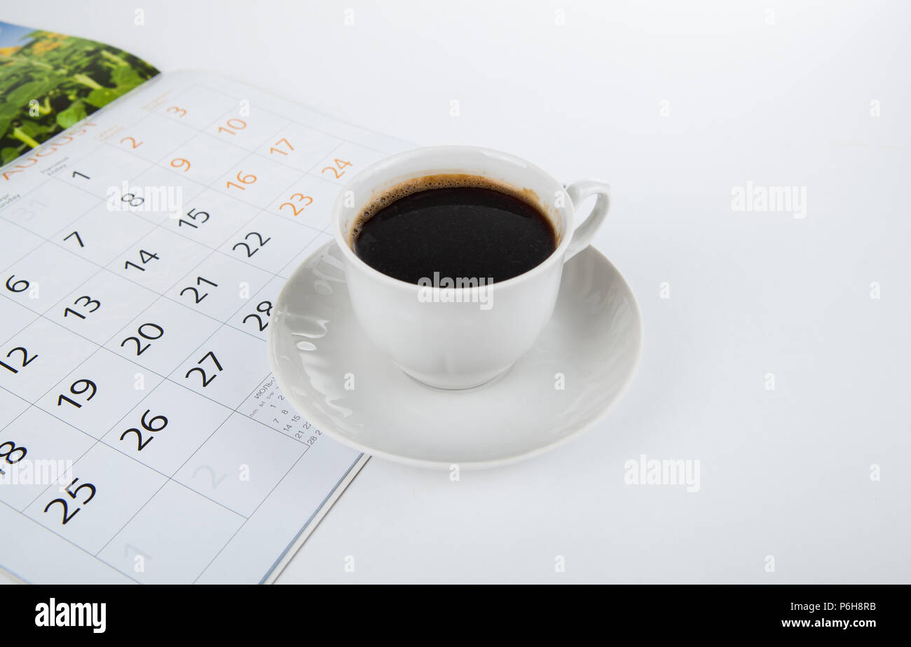 cup of coffee with wall calendar on a white background Stock Photo - Alamy