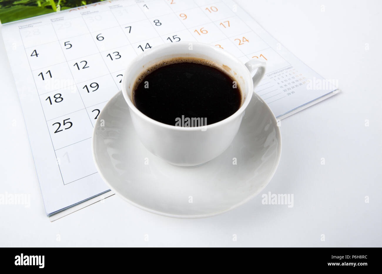 cup of coffee with wall calendar on a white background Stock Photo - Alamy