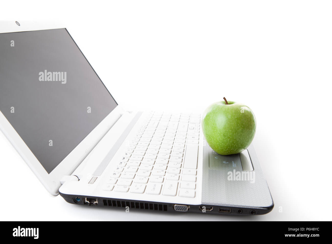 green apple on laptop keyboard on a white Stock Photo - Alamy