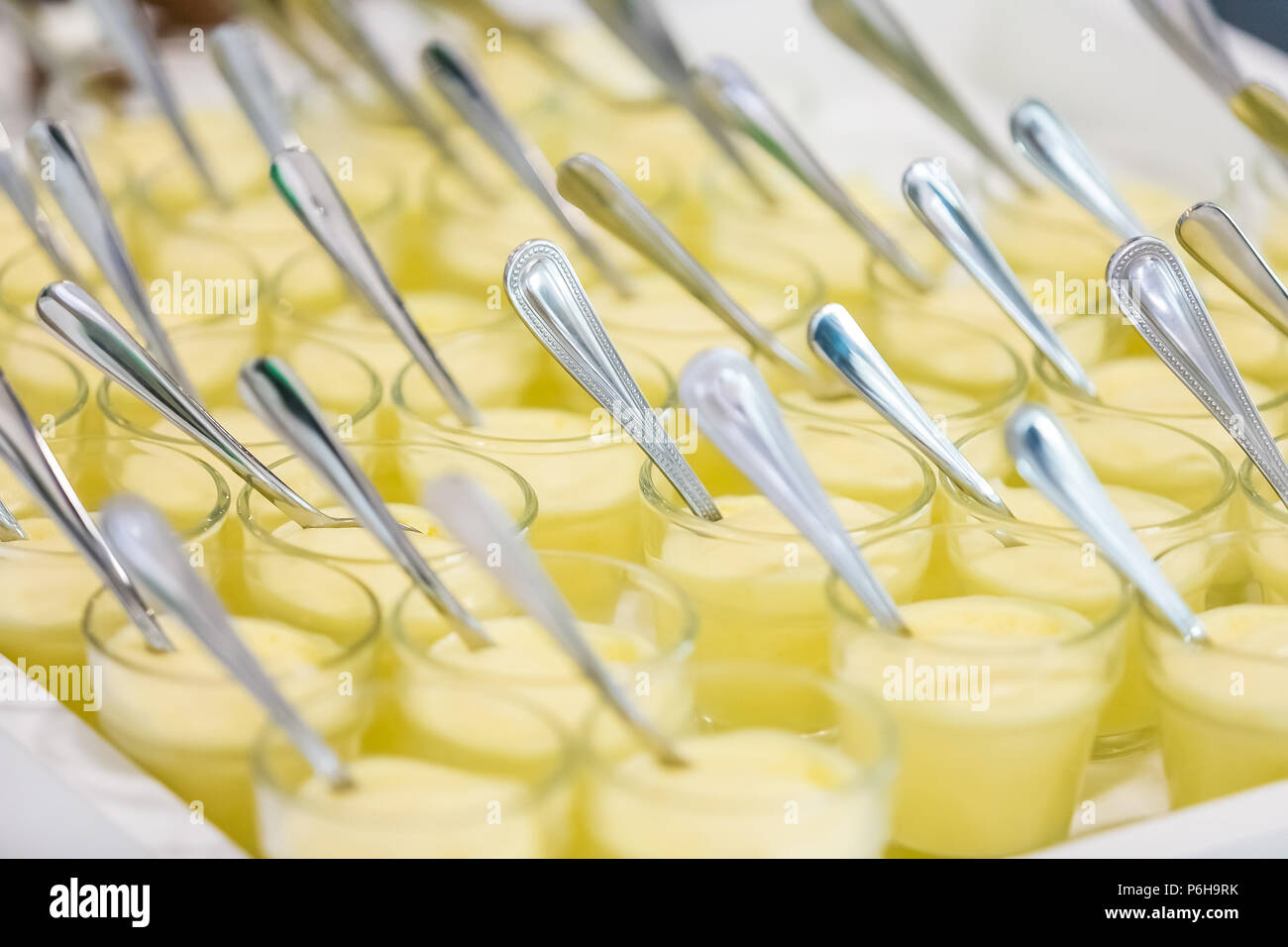 Small glasses of custard pudding dessert for catering at gala dinner ...
